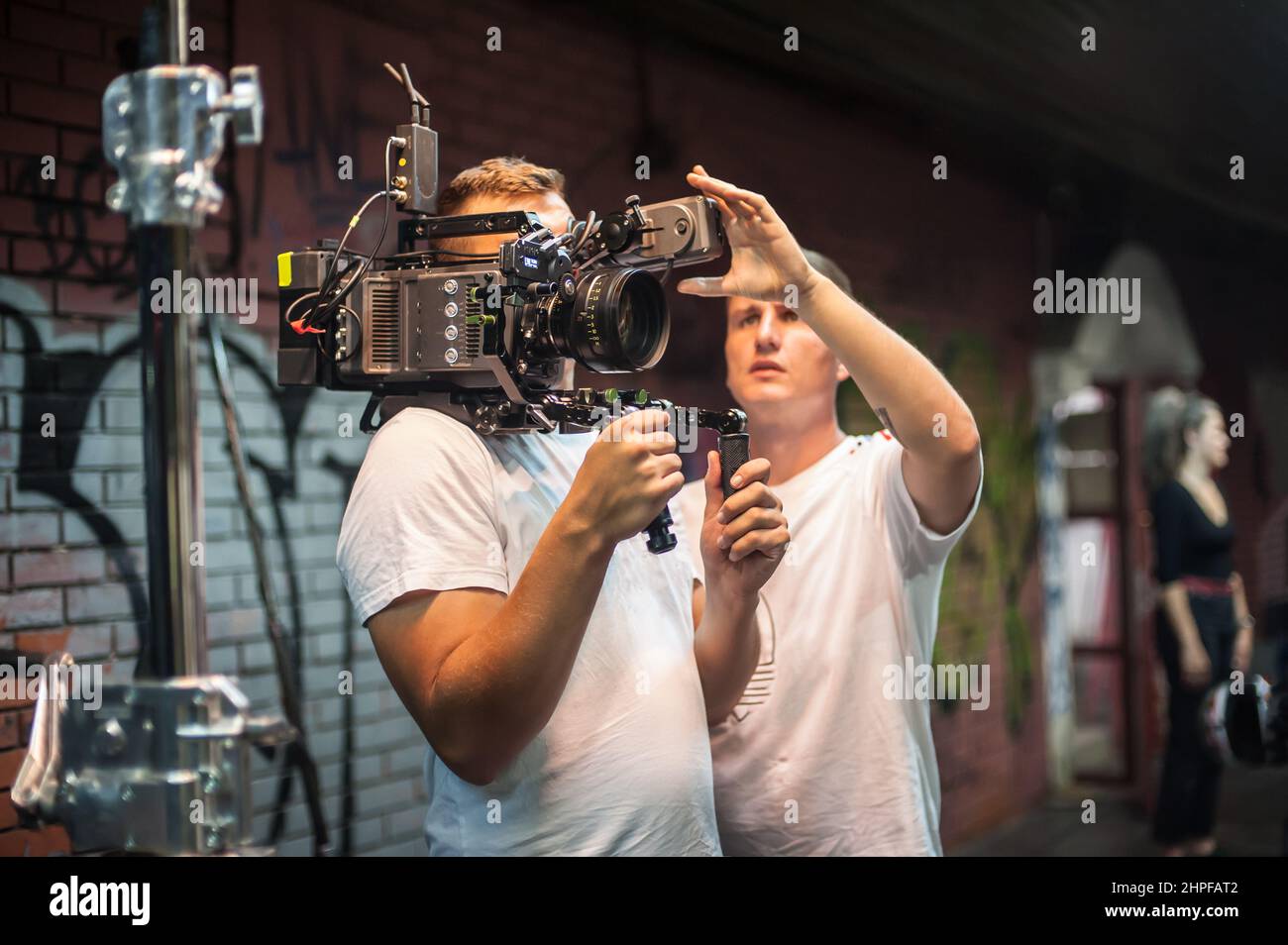 Behind the scenes. Cameraman shooting the film scene with his camera on ...