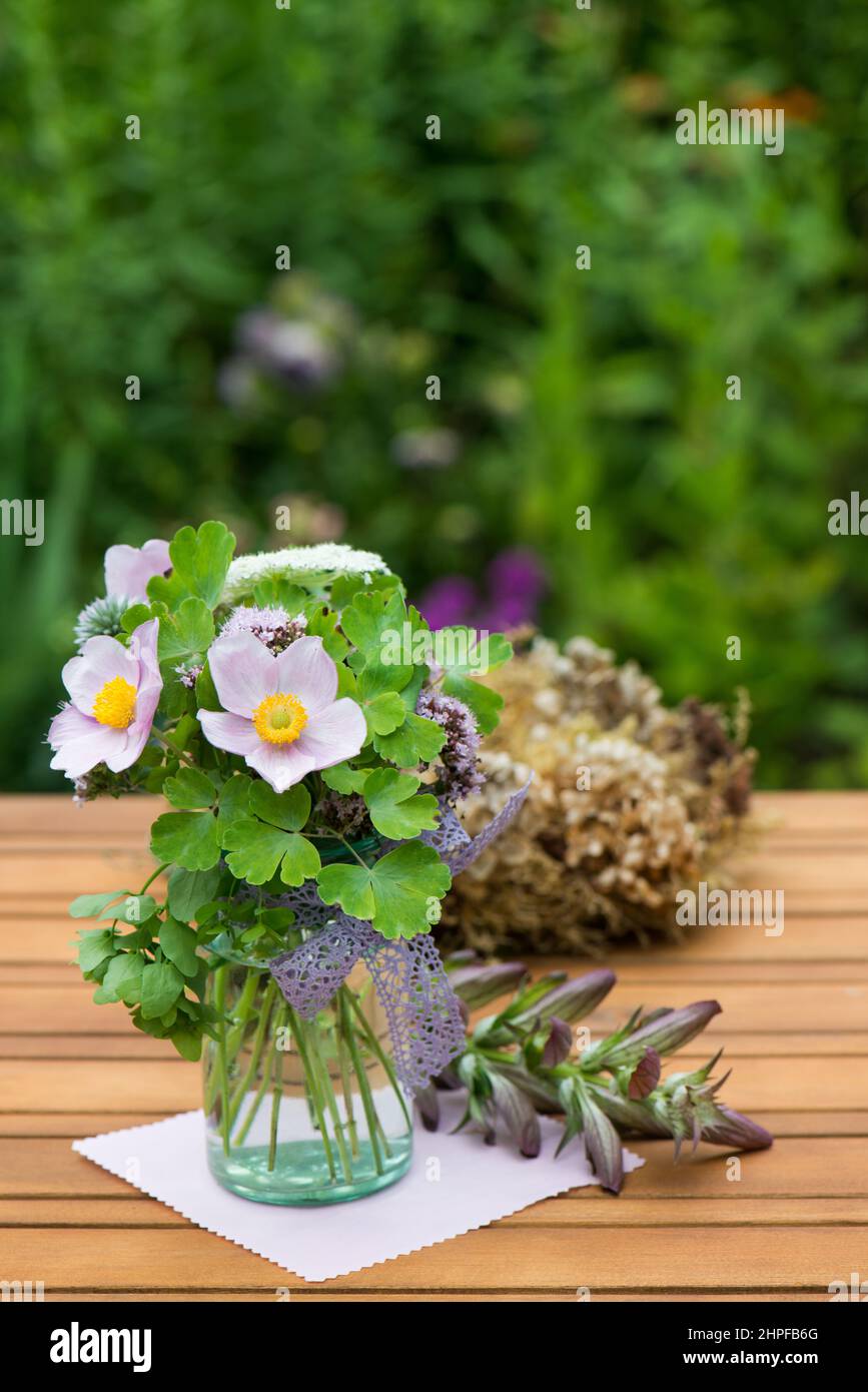 Flower bouquet on a wooden garden table Stock Photo - Alamy