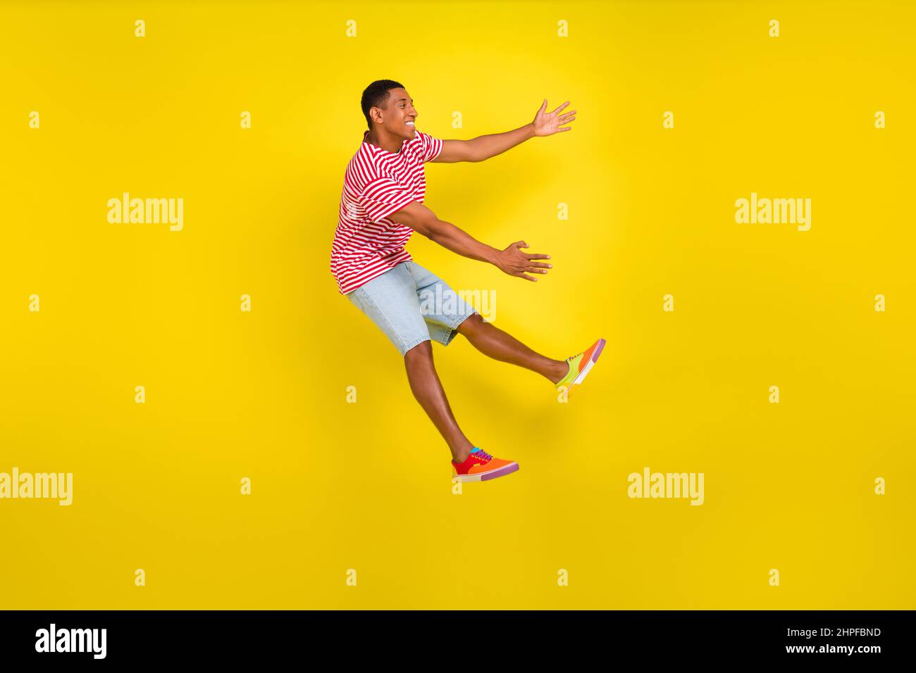 Full length profile side photo of guy jump hug big advert wear red ...