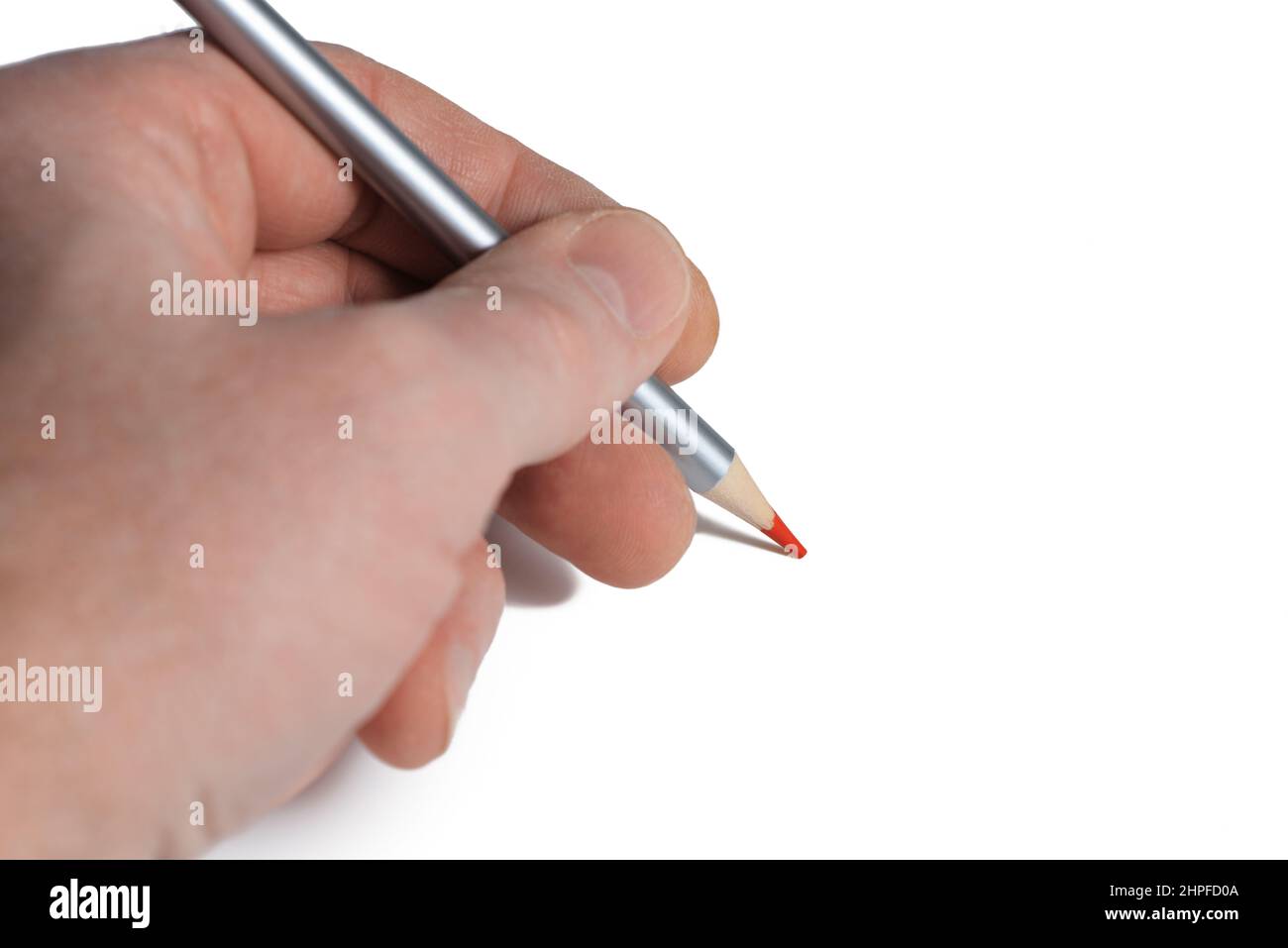 Red pencil in male left hand on blank paper white background. Left hand ...
