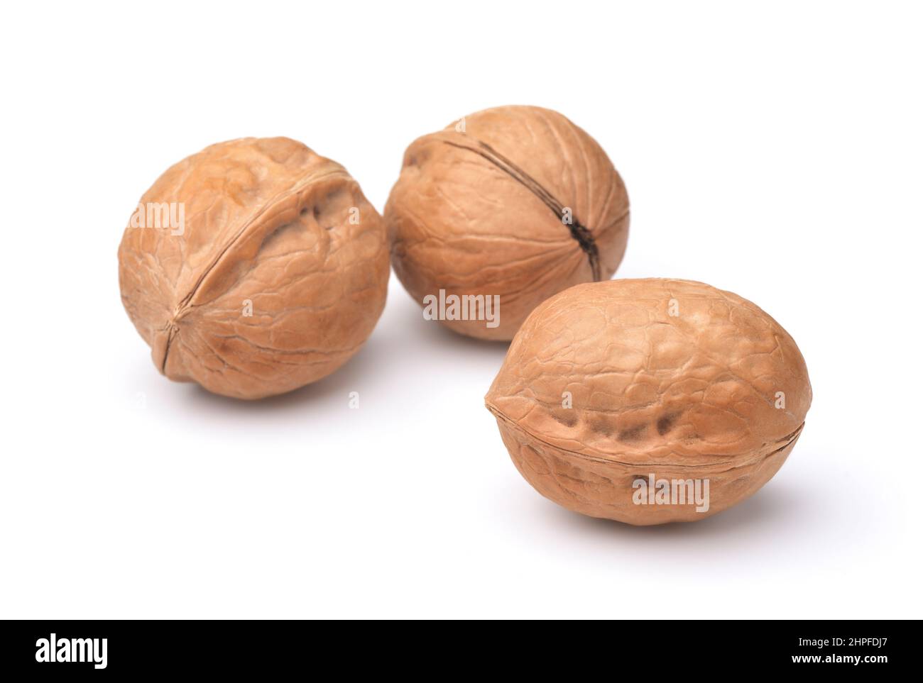 Three whole walnuts isolated on white Stock Photo - Alamy