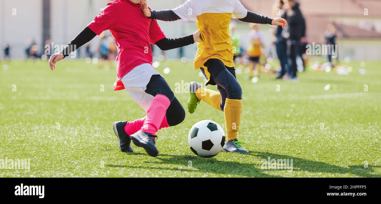 School girl and boy playing soccer game. Kids having fun and playing ...