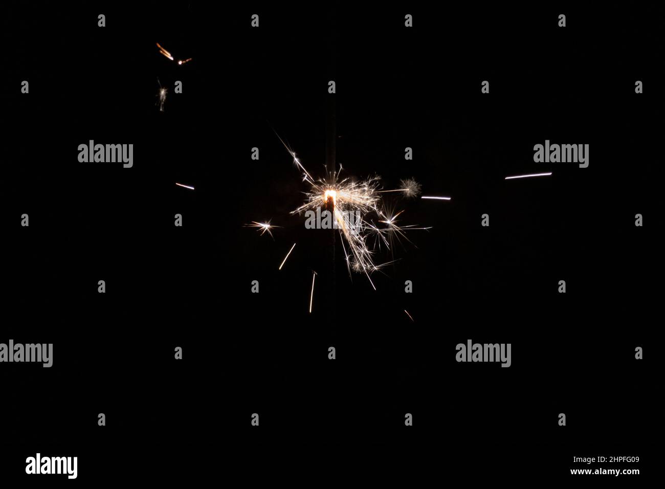 close up on ignited sparkler and its sparkles in the dark night Stock ...