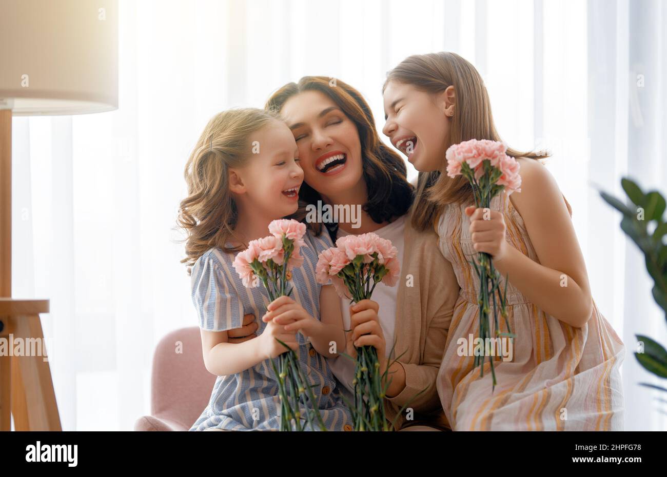 Happy day! Children daughters are congratulating mother and giving her ...