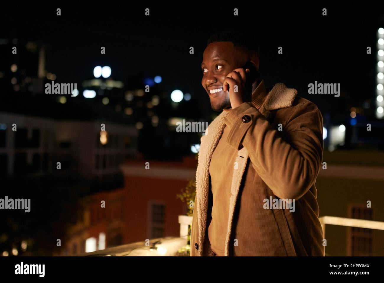 Independent, tall and handsome black male standing on rooftop terrace ...