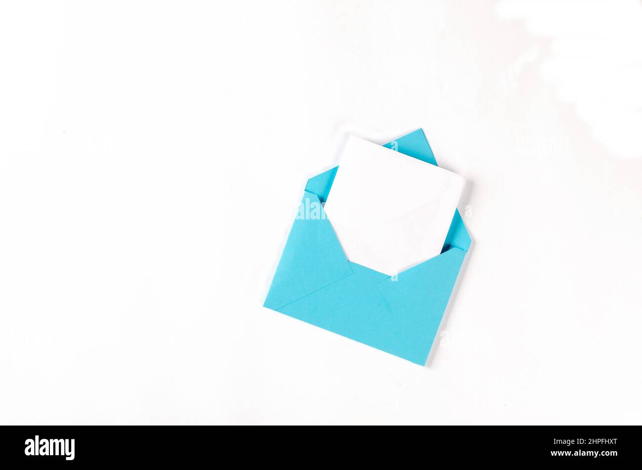 open blue envelope with white paper sheet on white background with ...