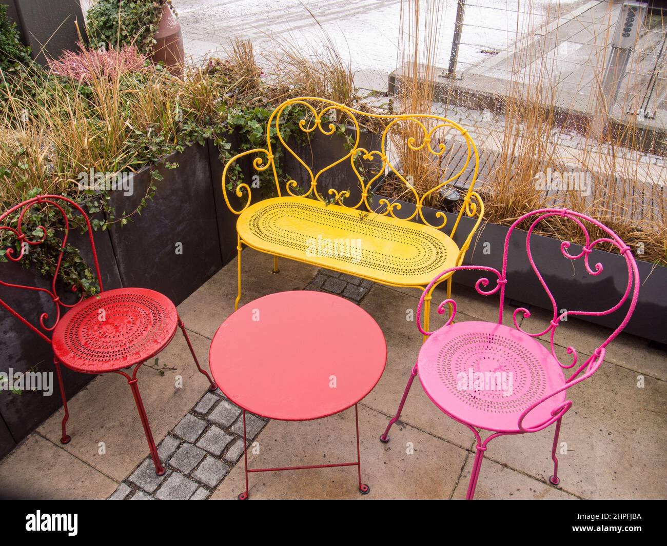 Pastel coloured cafe chairs and table Stock Photo - Alamy