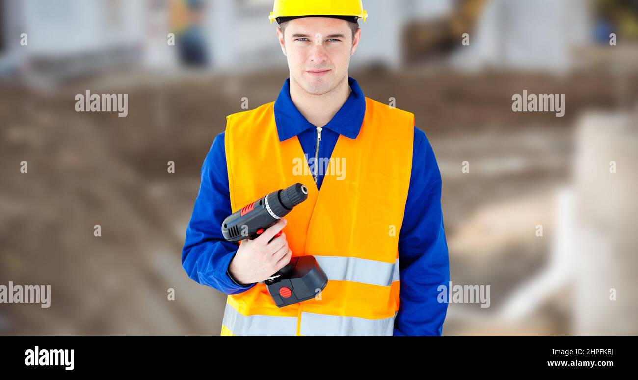 Portrait of confident young male labor holding power drill wearing ...