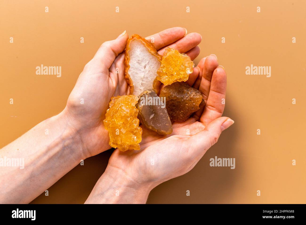 Hands holding natural mineral rock or shiny gemstone Stock Photo - Alamy