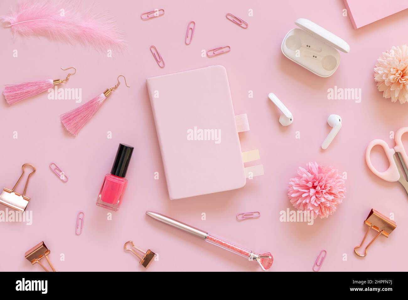 Hardcover notebook and Pink school accessories on pastel pink, top view ...