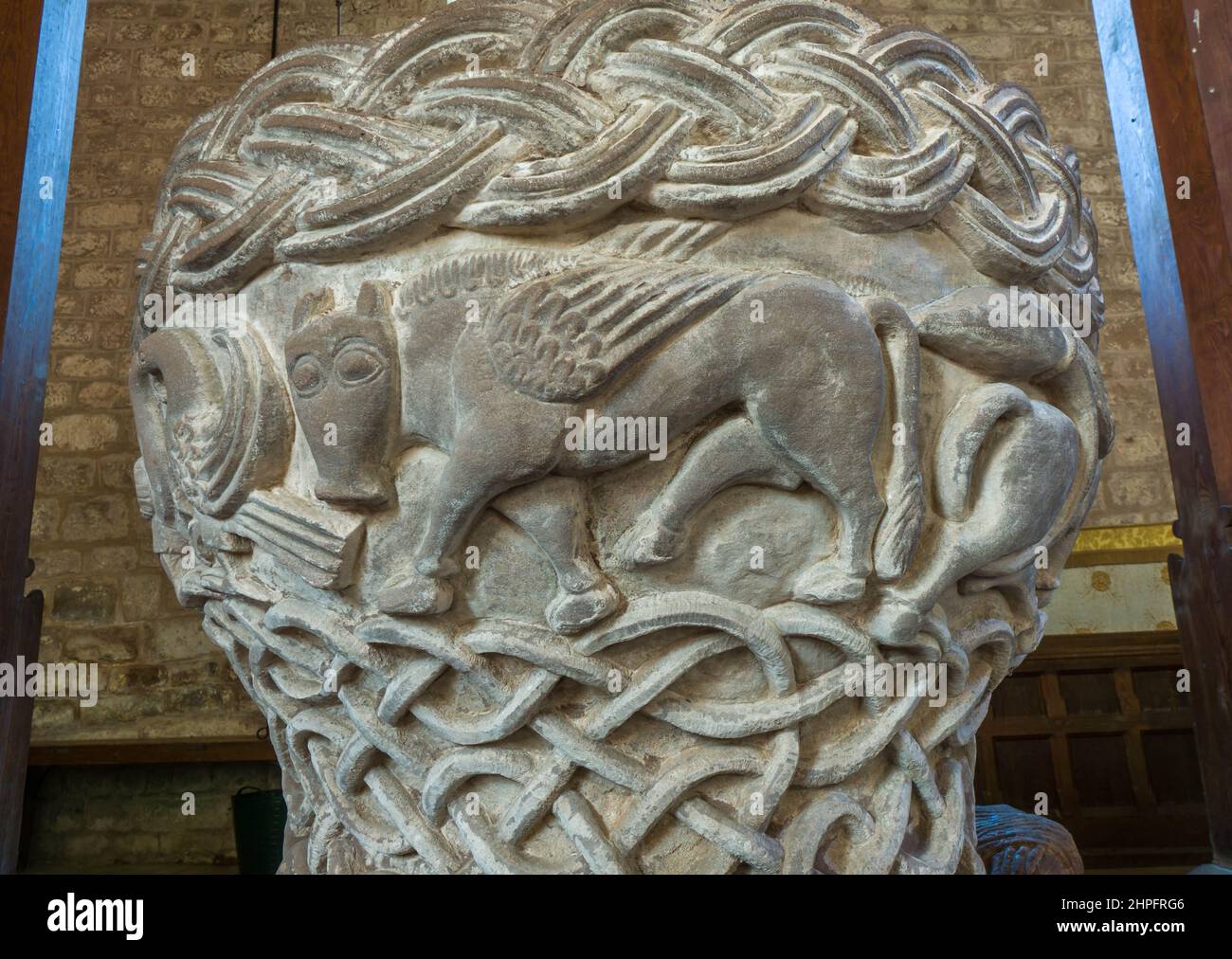 The winged Bull of St. Luke with entwined cable design above and ...