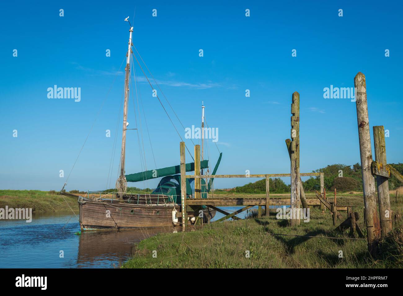 Old wooden sailing boat at its moorings in Thornham Old Harbour as the ...