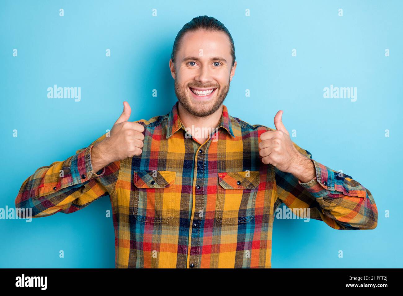 Photo of cool young brunette guy show thumb up wear yellow shirt ...