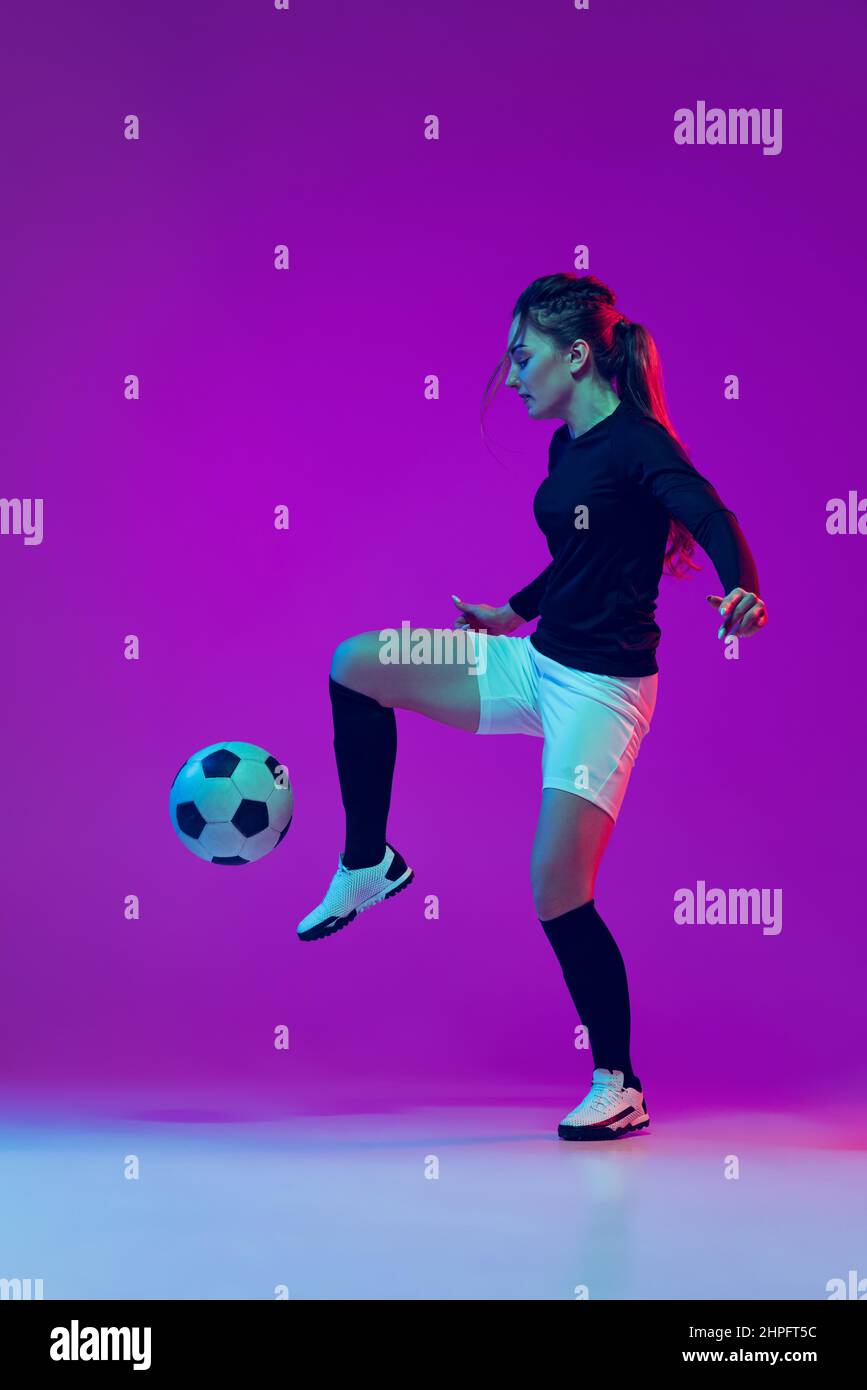 One sportive girl, female soccer player kick in jump football ball ...