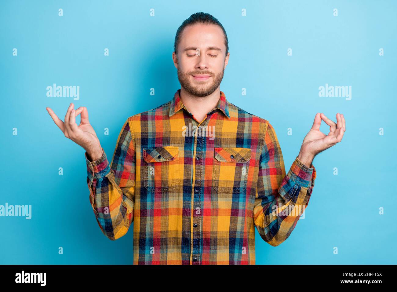 Photo of sleepy young brunette guy do yoga wear checkered shirt ...
