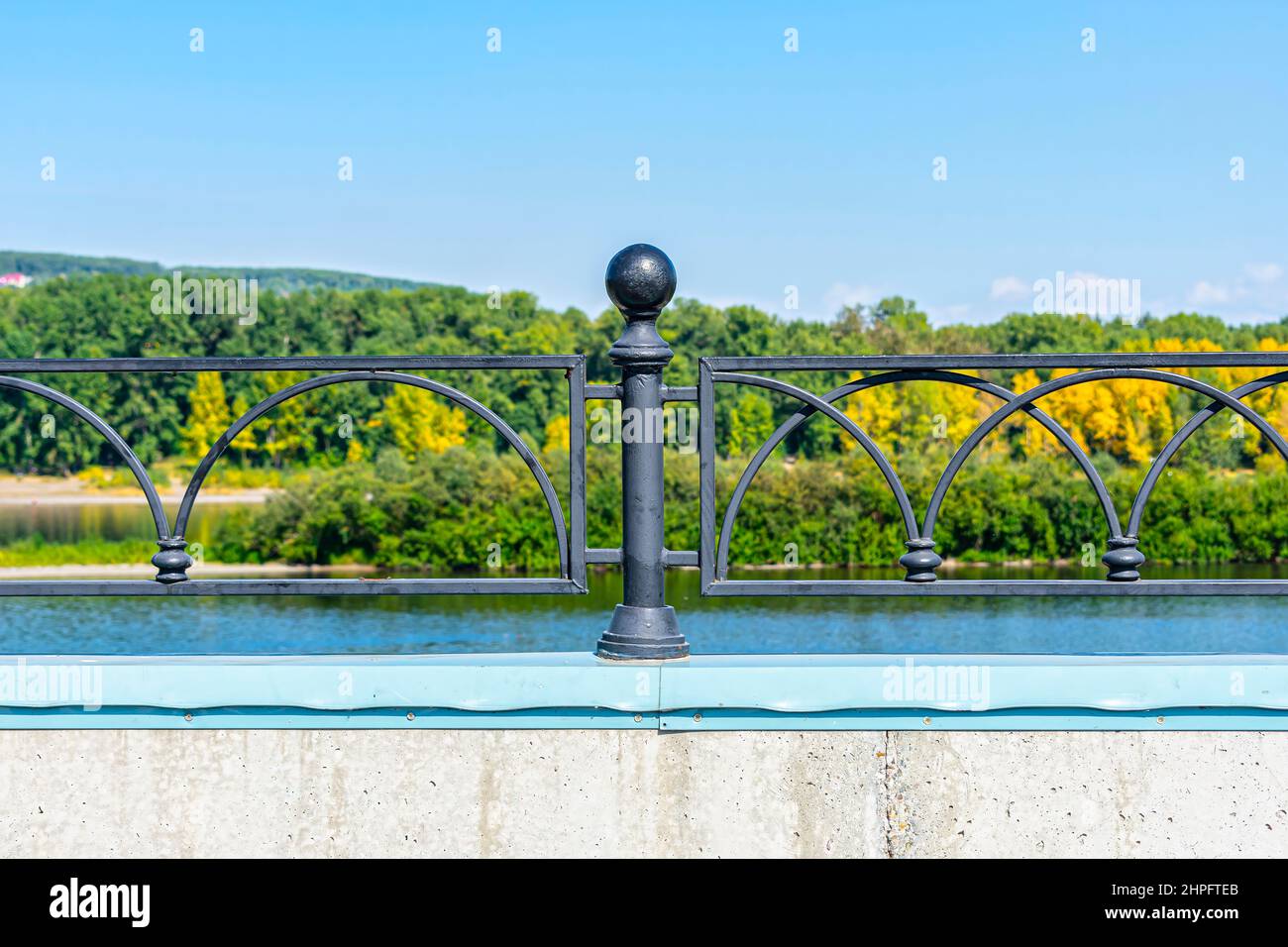 Black decorative fence on the embankment against the background of the ...