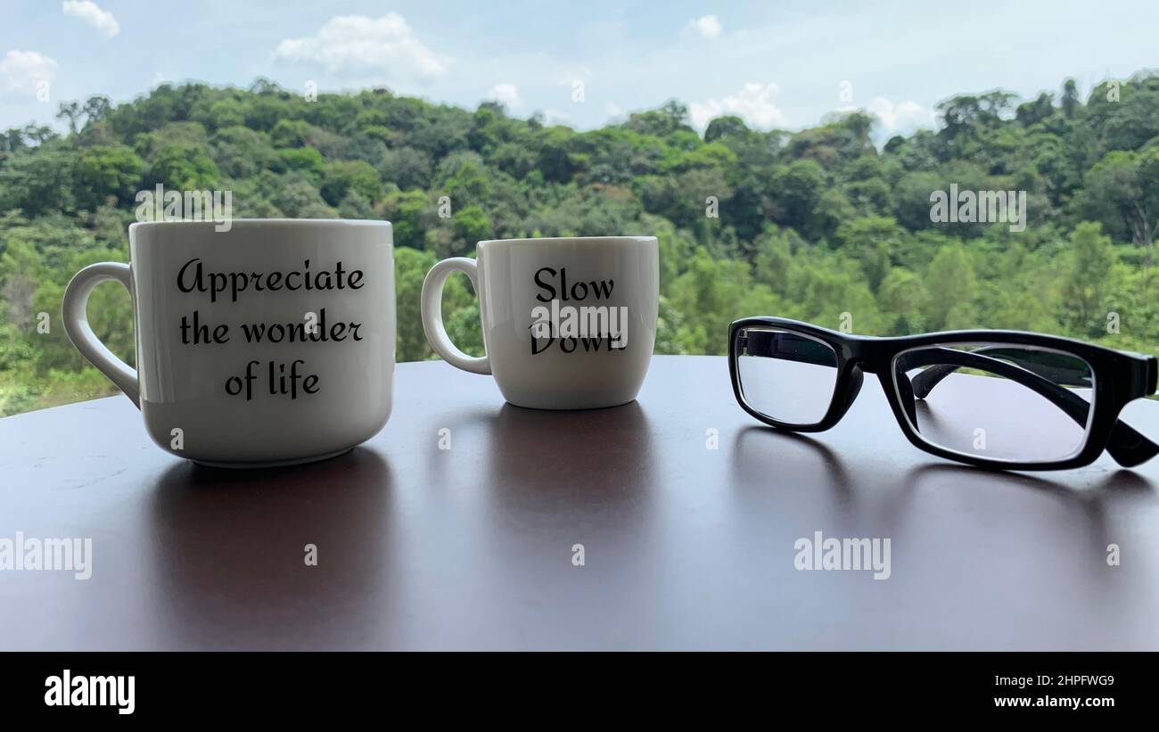 Motivational and inspirational quote text on coffee cups. Slow down ...
