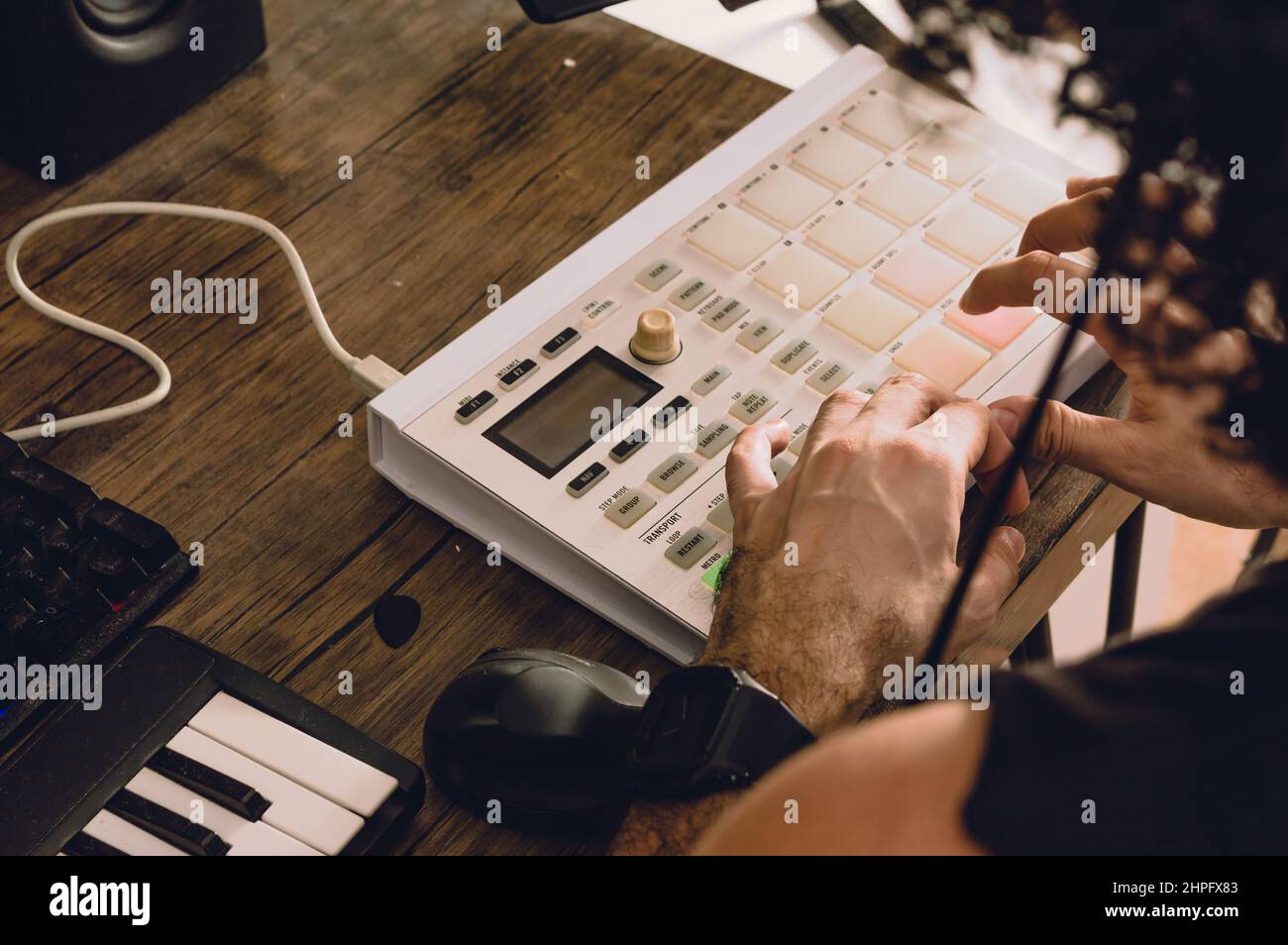 rear view of caucasian man making beats on a midi controller in his ...