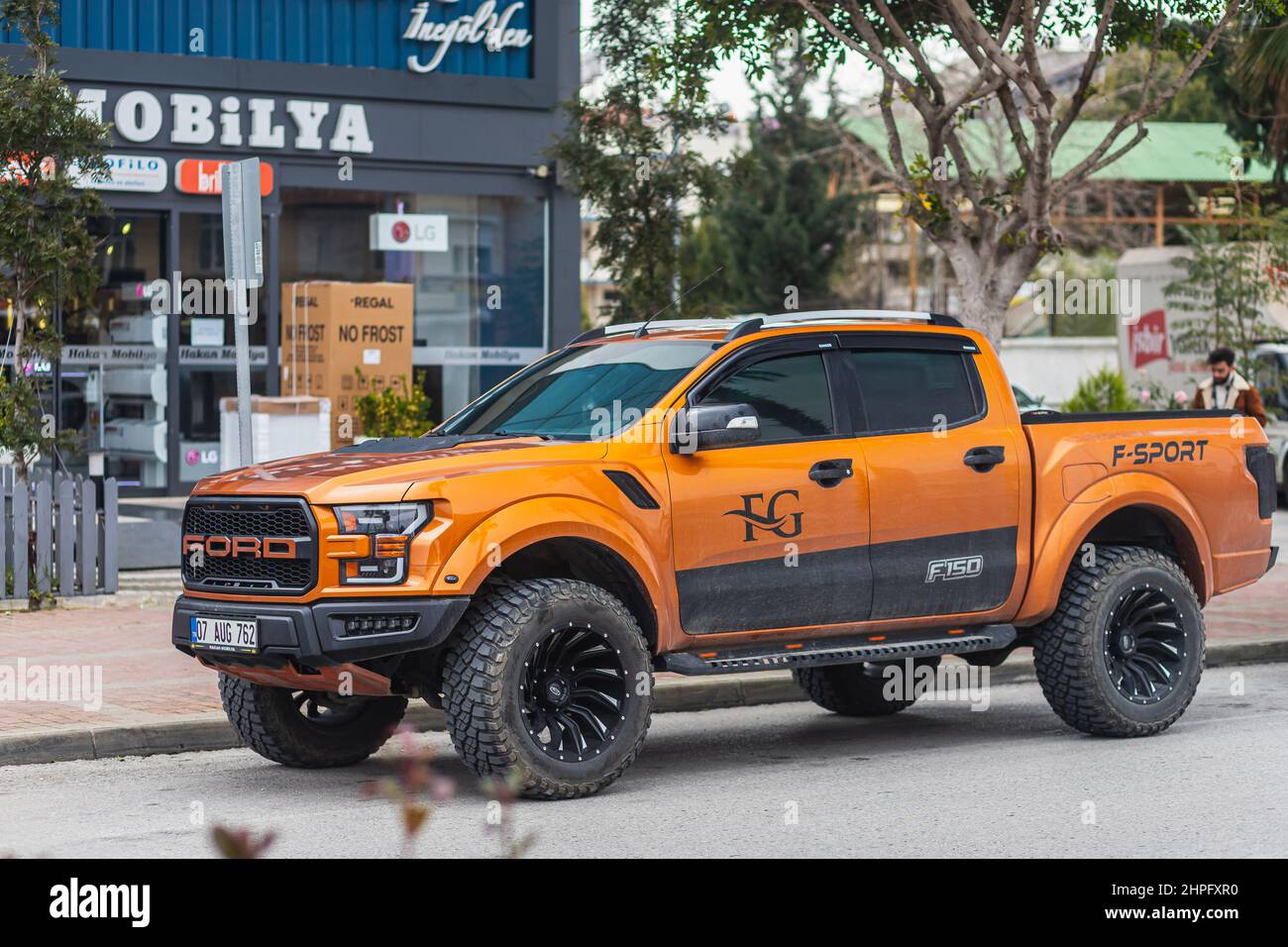 Side, Turkey -January 27, 2022: orange pickup Ford F-150 is parking on ...
