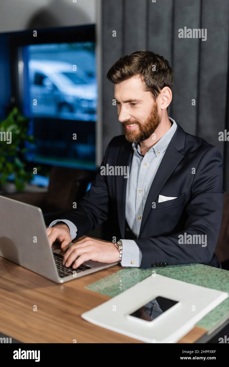 Cheerful businessman type phone hi-res stock photography and images - Alamy