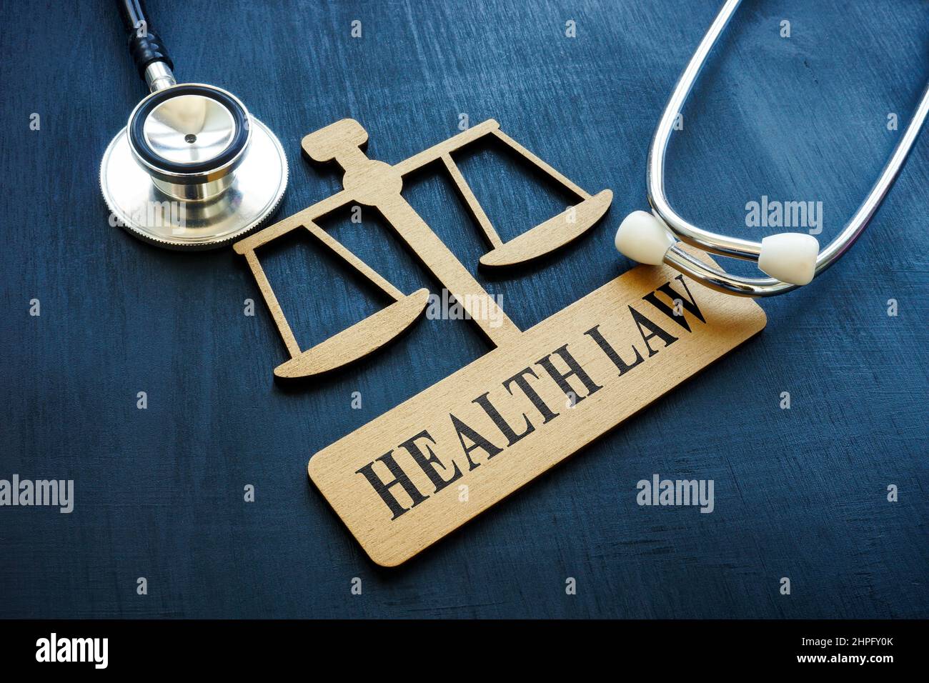 A plate in the form of scales with an sign Health law Stock Photo - Alamy