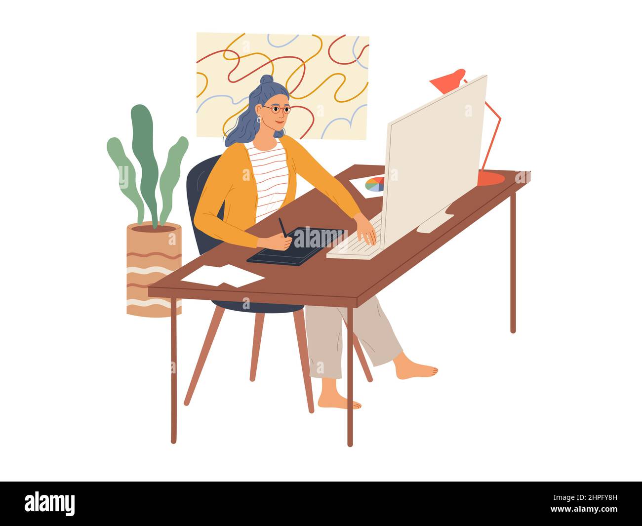 Woman works at her computer using a graphics tablet. An employee of the ...