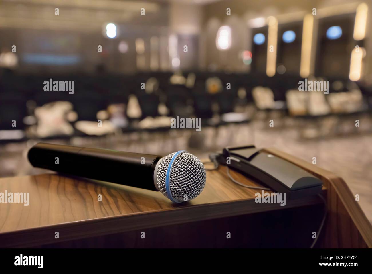 There is a microphone on the table against the background of an empty ...