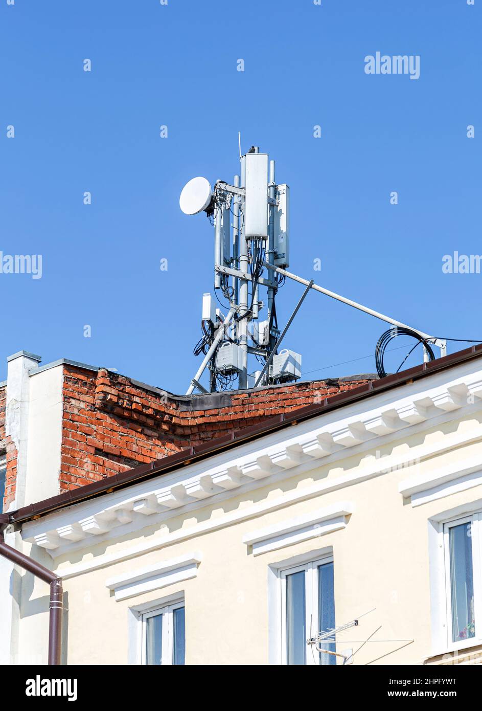 Telecommunication tower for mobile phone with antennas on a roof of ...