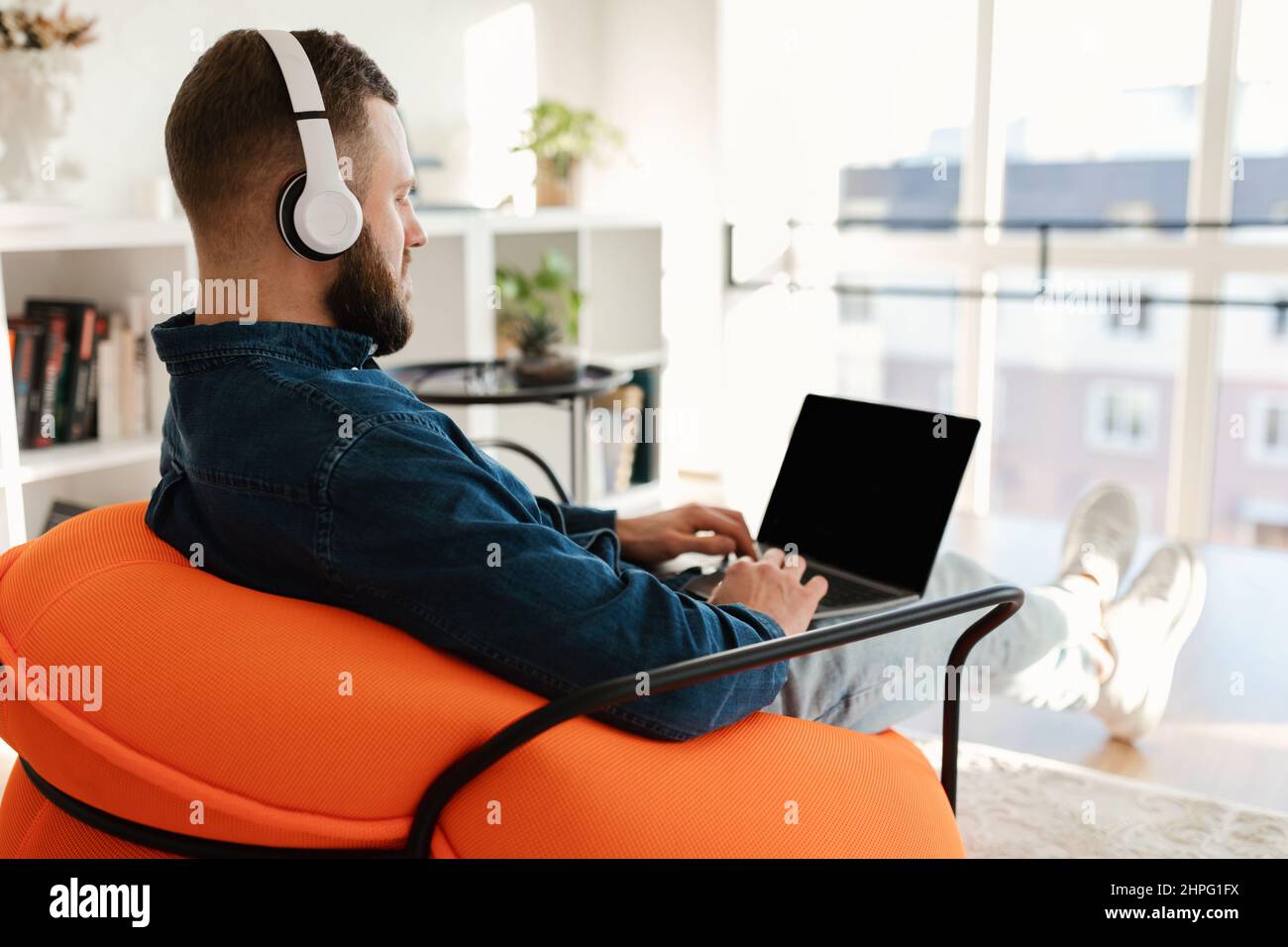 Millennial Guy Using Laptop With Blank Screen Wearing Wireless ...