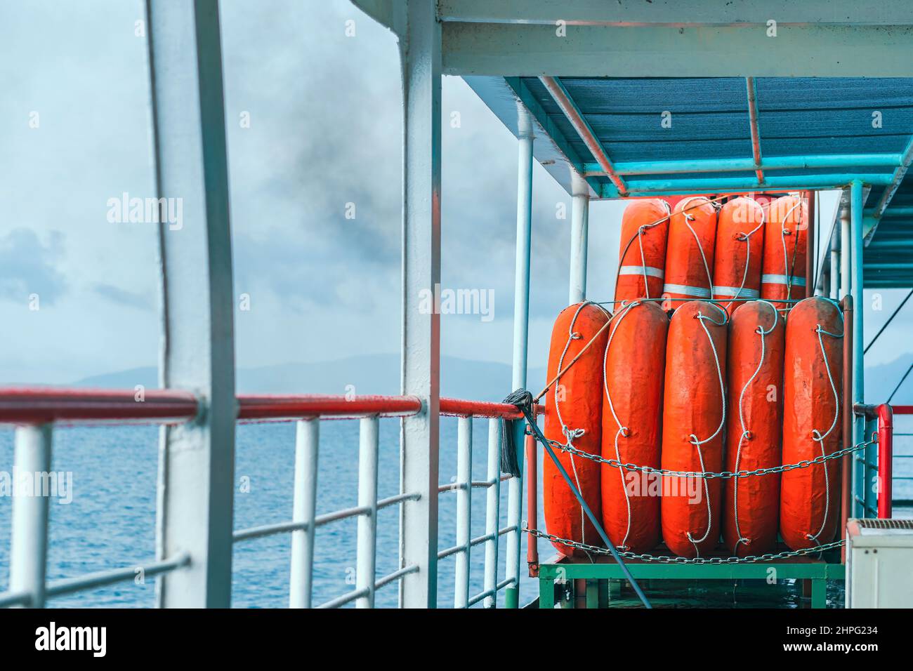 Orange inflatable lifeboats on ferry deck for emergencies and maritime ...