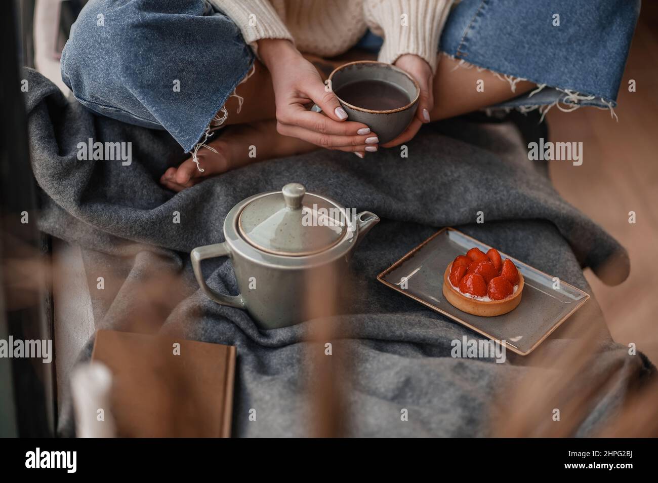 Close up picture of a girl having tea while sitting on the floor Stock ...