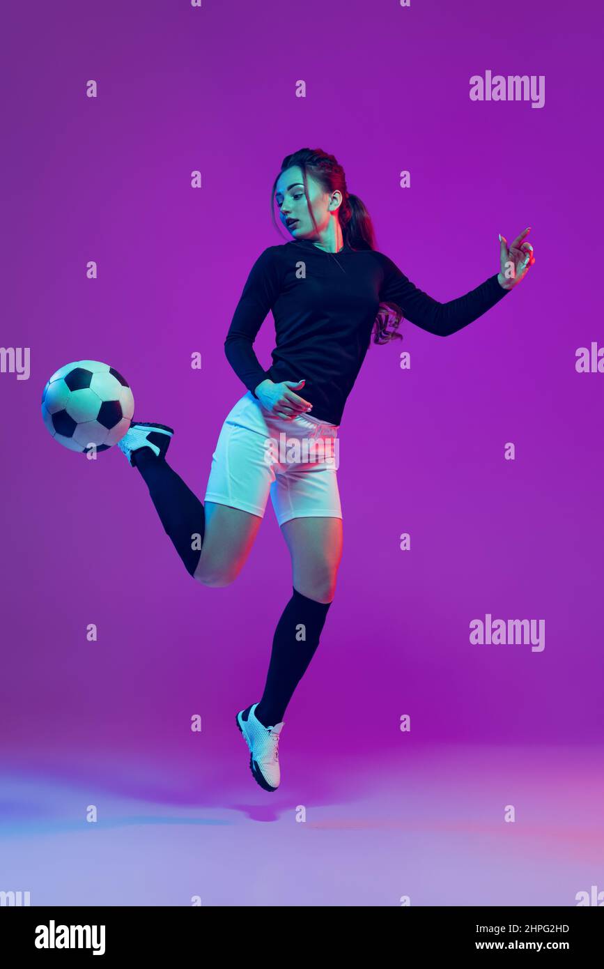 One sportive girl, female soccer player kick in jump football ball ...