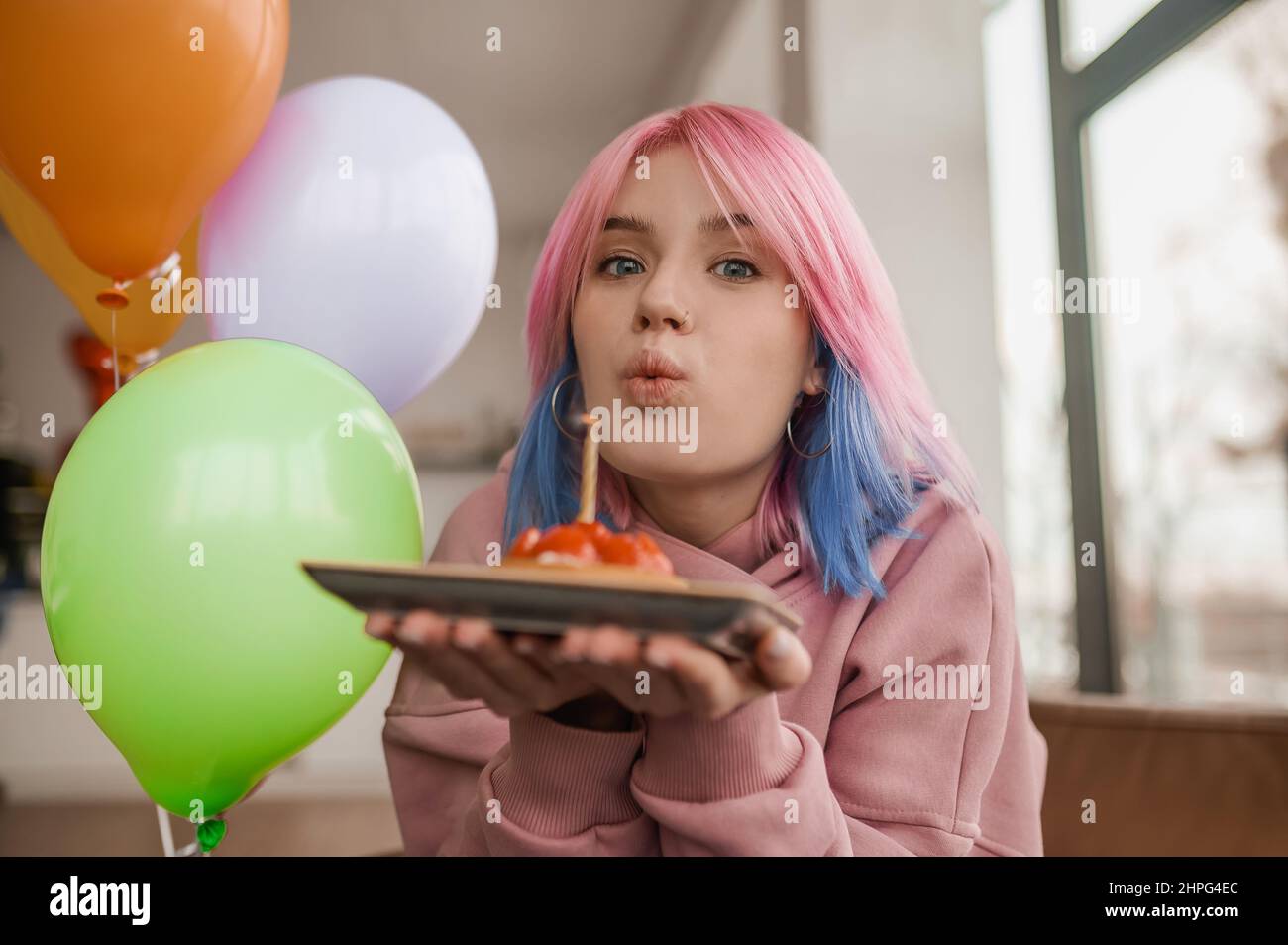 A pretty young girl holding a saucer with a cake Stock Photo - Alamy