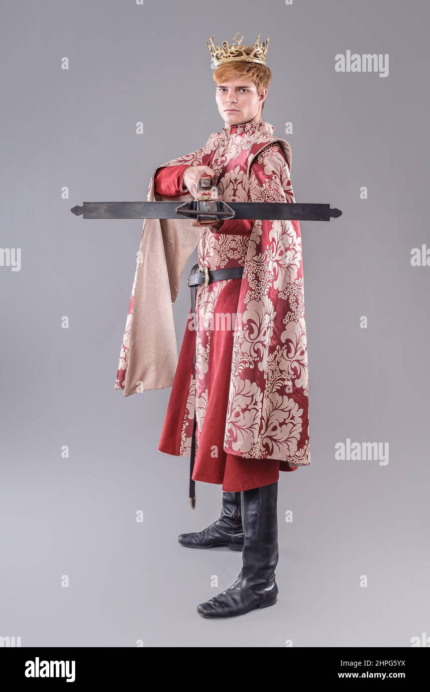 Medieval king with sword and crown Stock Photo - Alamy
