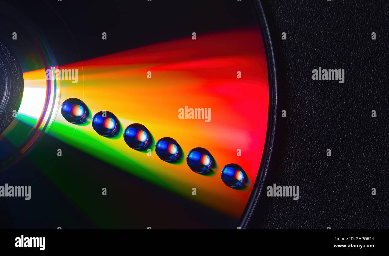 Shiny raibow colored water drops on the old compact CD disc, design for ...
