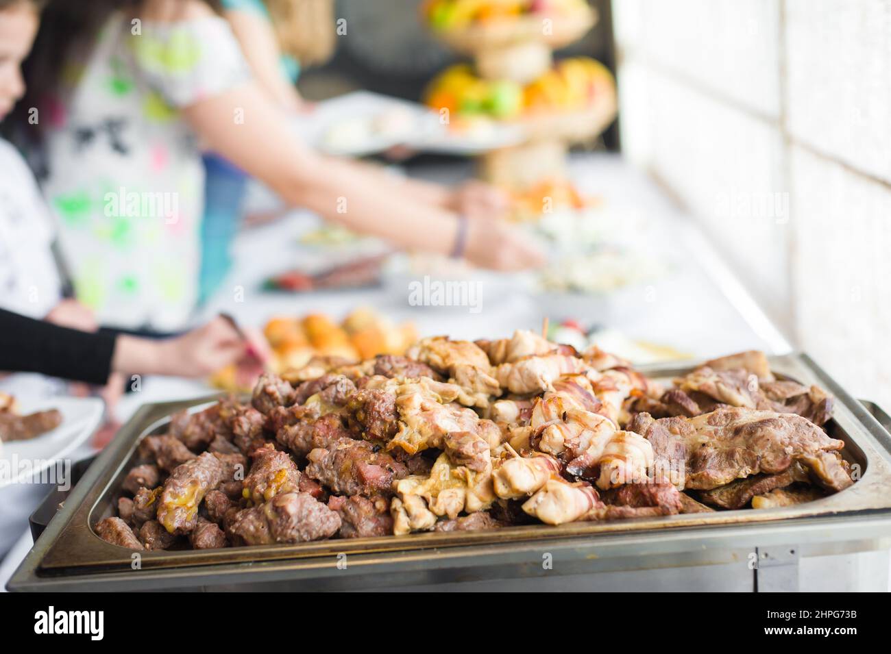 Catering buffet table with a delicious food. Meat and vegetable Stock ...