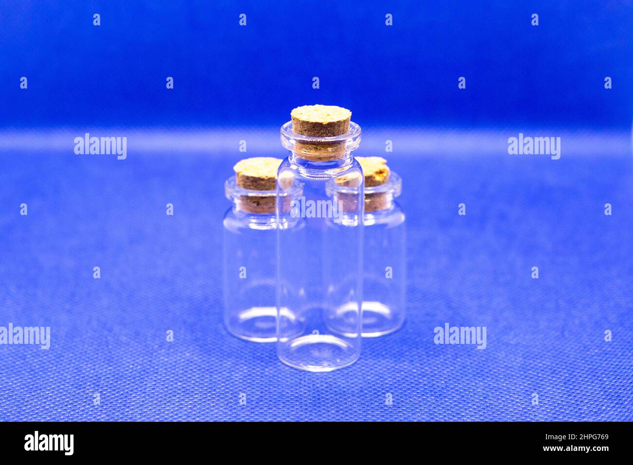 Three empty glass bottles with stoppers storing small parts Stock Photo ...