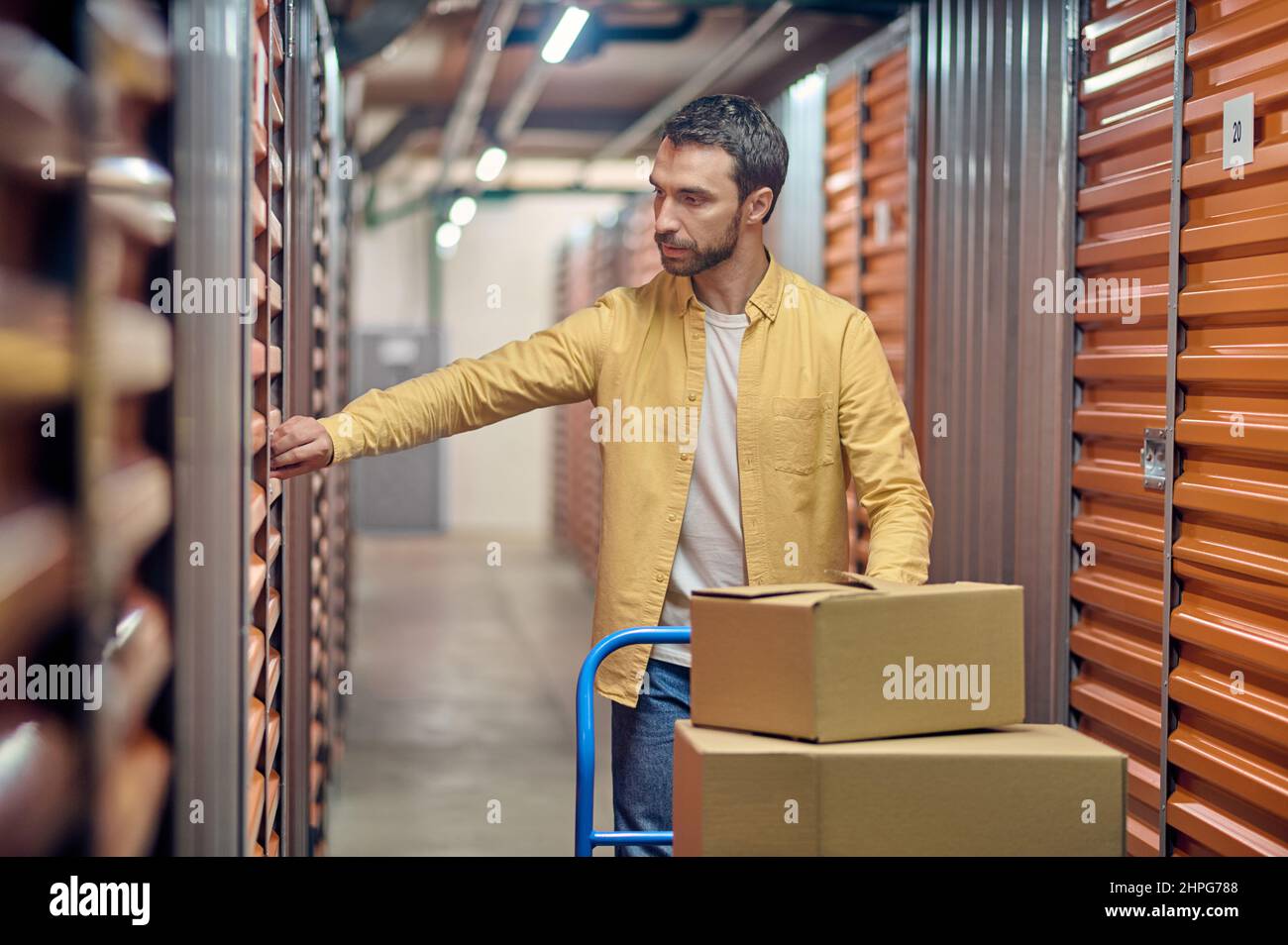 Experienced order picker choosing ordered items for customers Stock ...