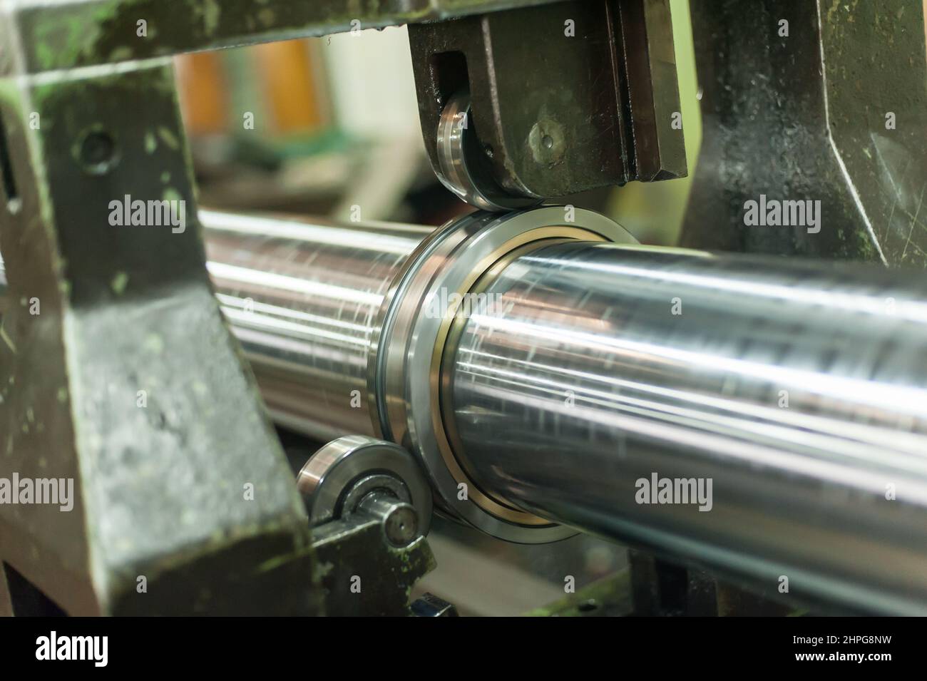 Old mechanic circular drum cylinder machine working at the factory ...