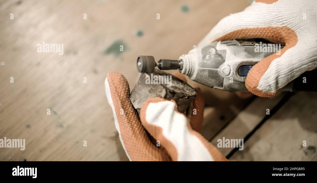 Carpenter using electric hand grinder. Close up Stock Photo - Alamy