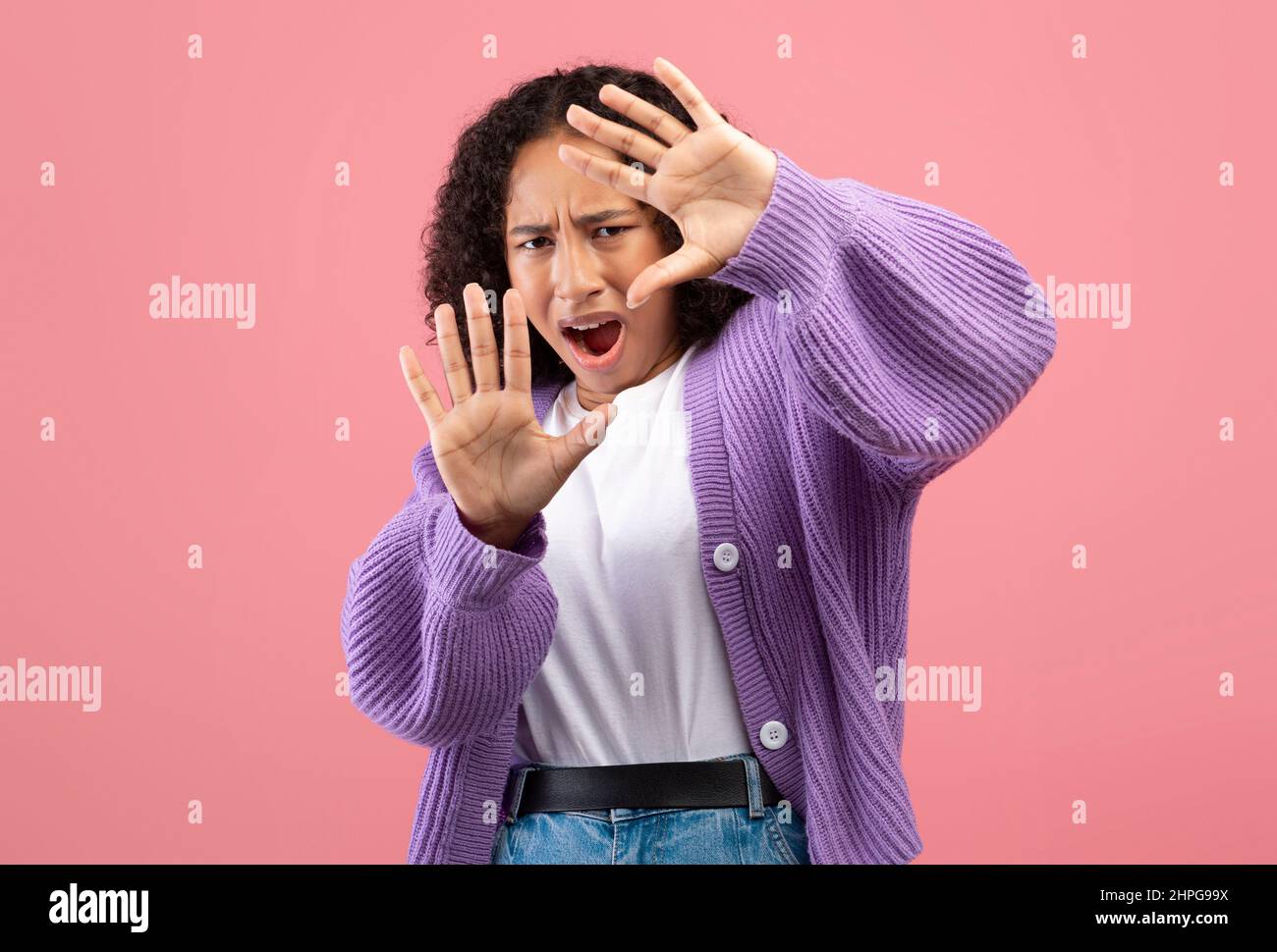 Young African American woman feeling scared, shouting in fear, trying ...