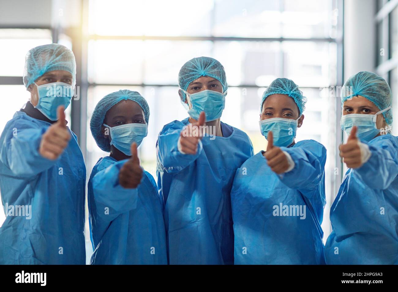 The surgery was a success. Portrait of a group of medical practitioners ...