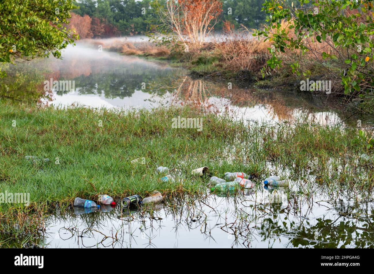 Litter and rubbish dumped in a river. Plastic pollution destroying the ...