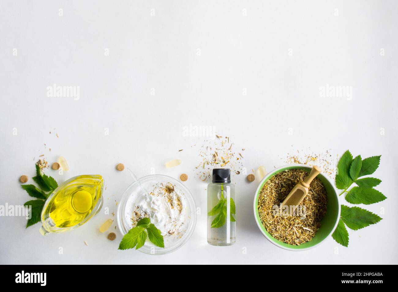 Alternative medicine, herbal extract: white background, hands hold a ...