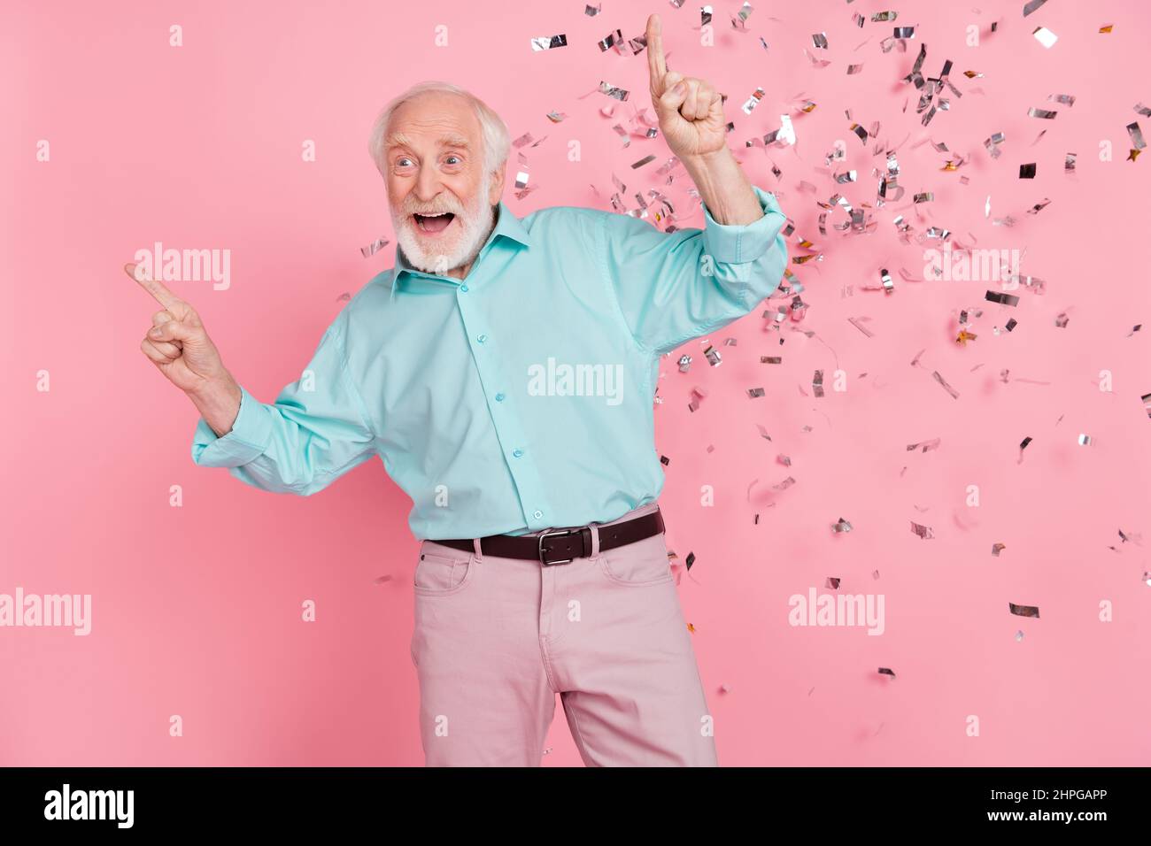 Photo of amazed middle aged man finger point dance confetti fall ...