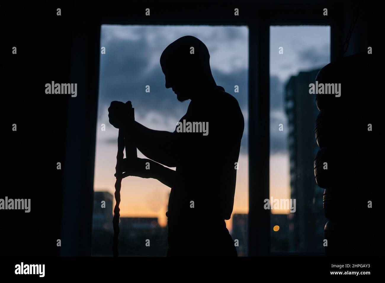 Silhouette of unrecognizable boxer male wrapping defense boxing tape ...