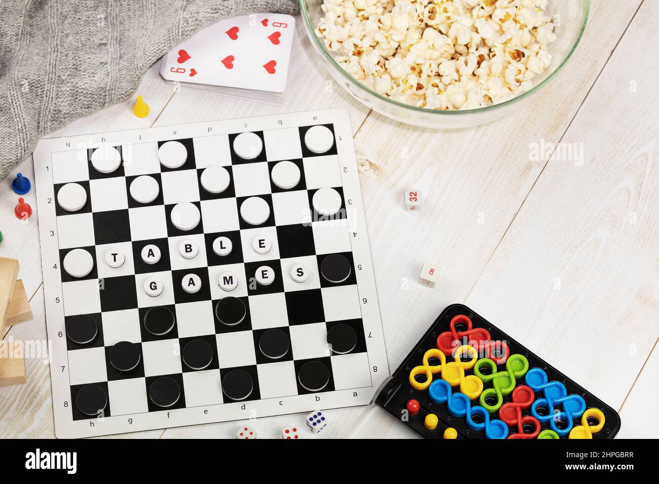 Table games. Checkers, puzzle, cards, dominoes, jenga on a wooden floor ...