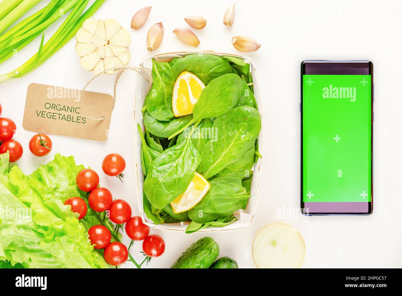 Natural vegetables and smartphone with green screen on a white ...