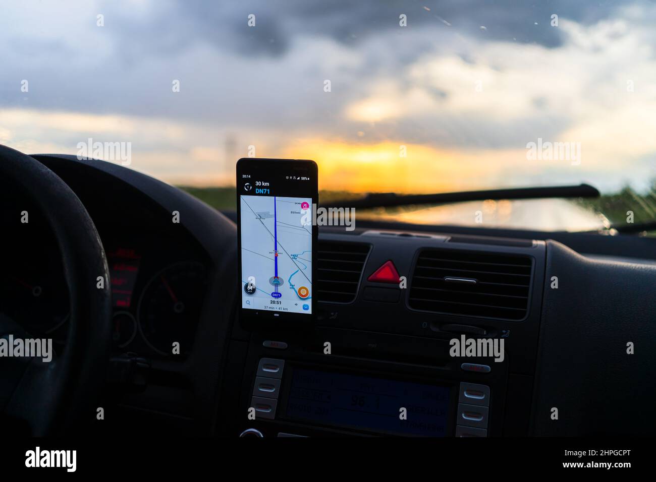 Using waze maps application on smartphone on car dashboard, Driver ...