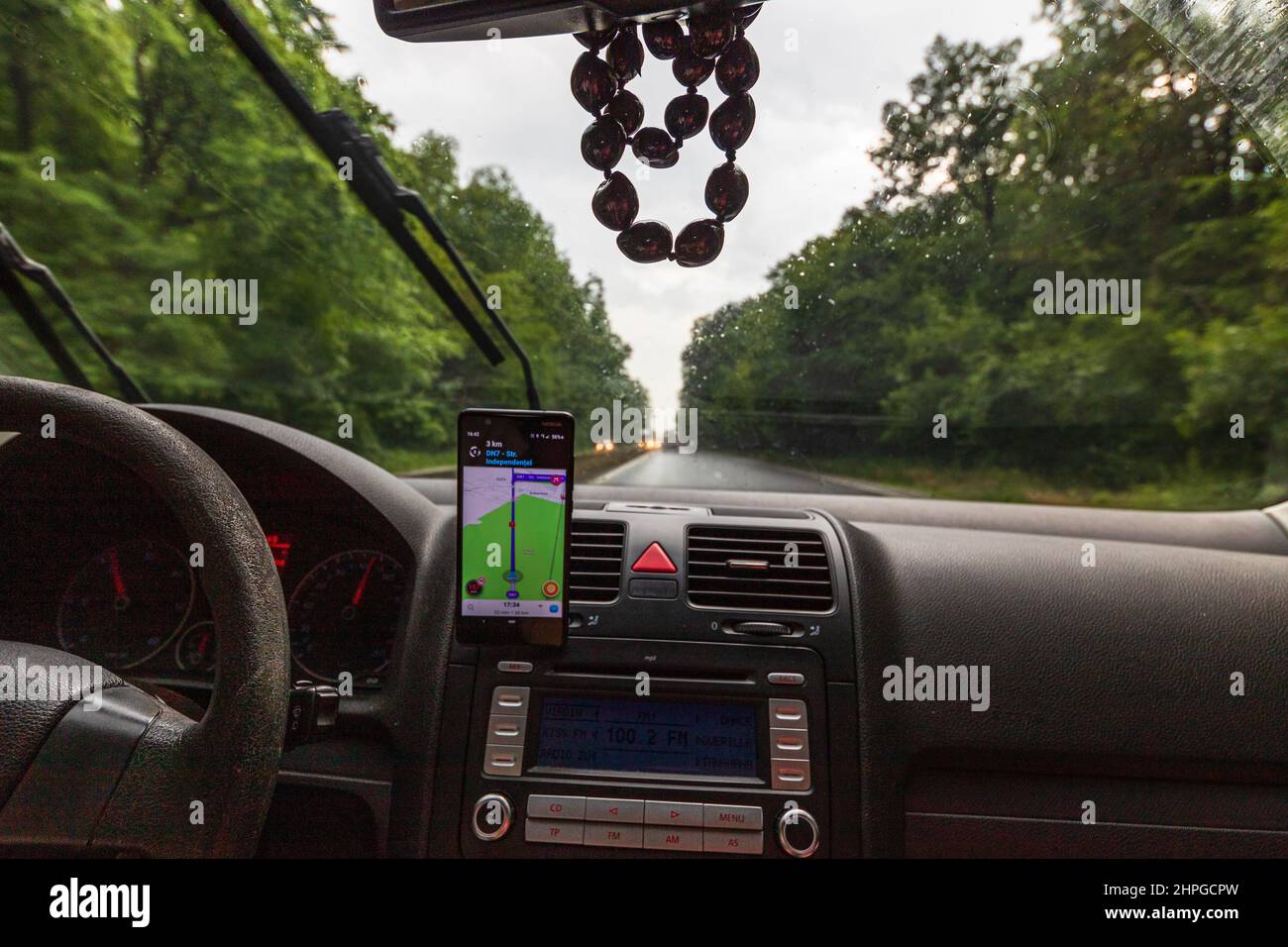 Using waze maps application on smartphone on car dashboard, Driver ...
